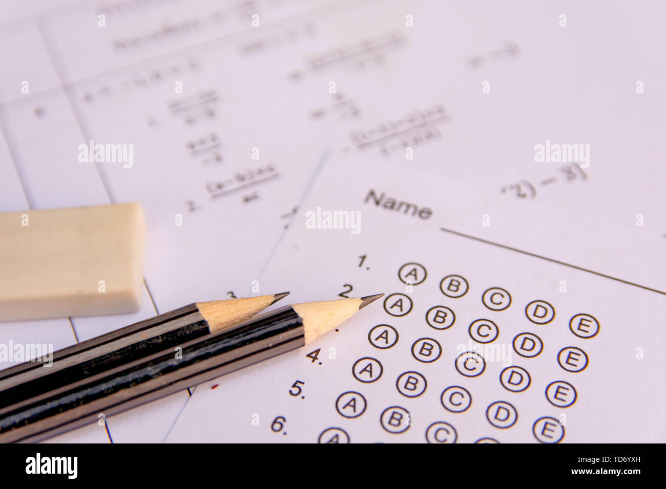 Pencil and eraser on answer sheets or Standardized test form with ...
