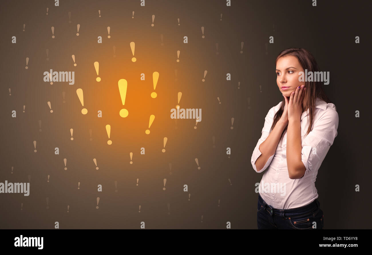 Young person standing with exclamation sign concept Stock Photo - Alamy