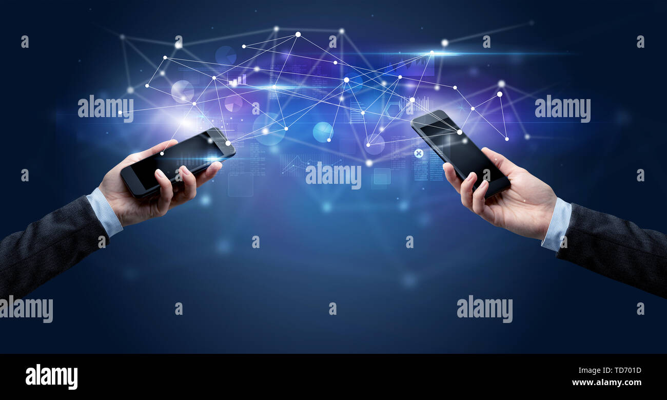 Close up of two hands holding smartphones and sharing business data ...