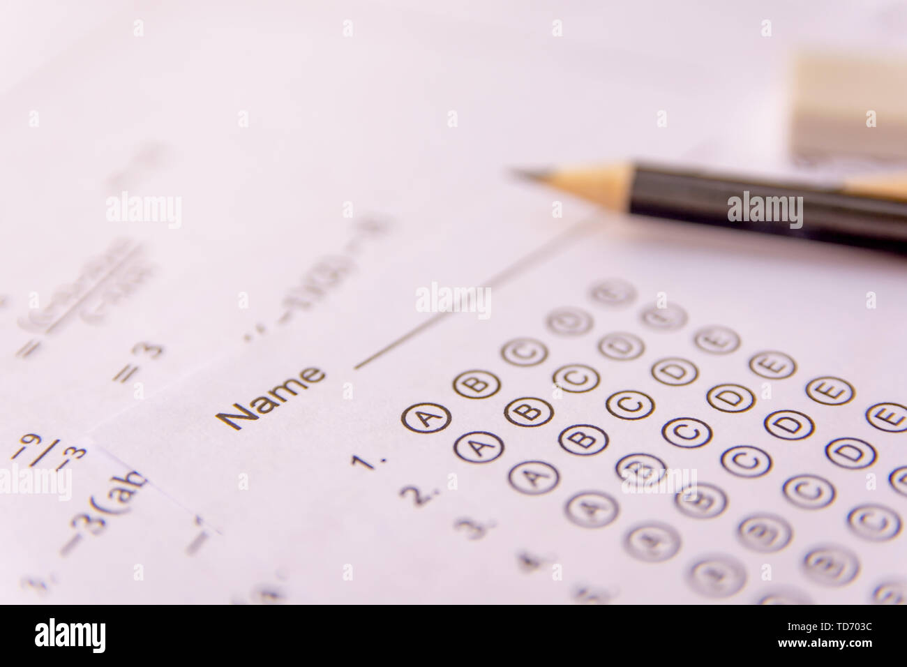 Pencil and eraser on answer sheets or Standardized test form with ...