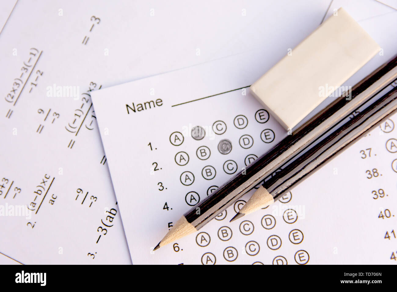 Pencil and eraser on answer sheets or Standardized test form with ...