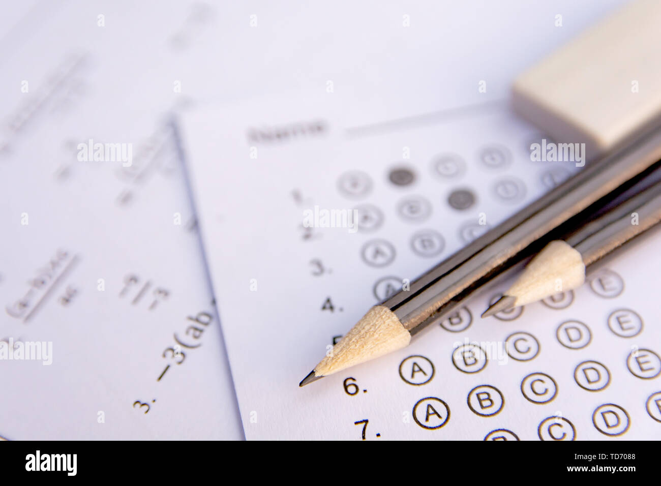 Pencil and eraser on answer sheets or Standardized test form with ...