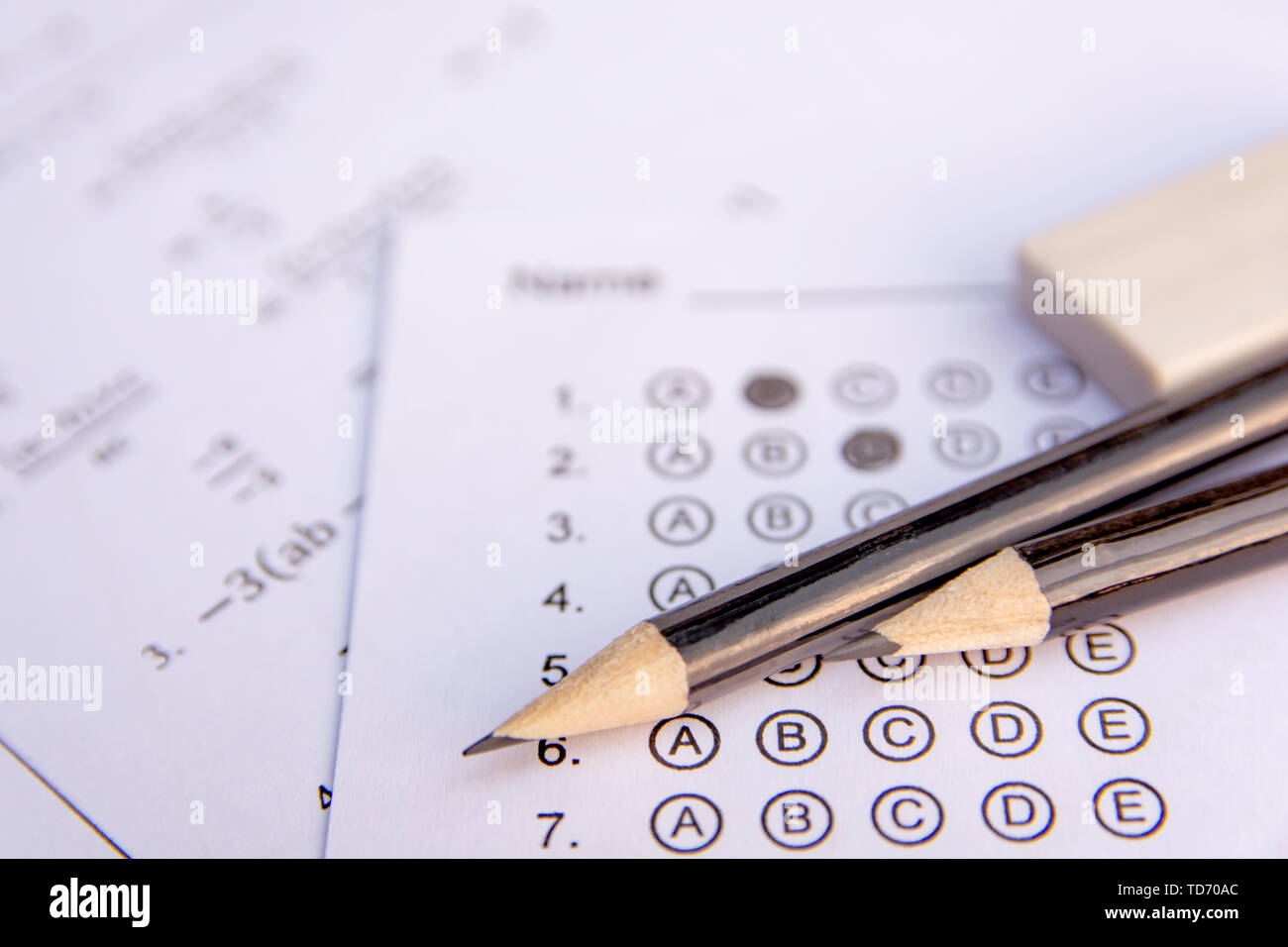 Pencil and eraser on answer sheets or Standardized test form with ...