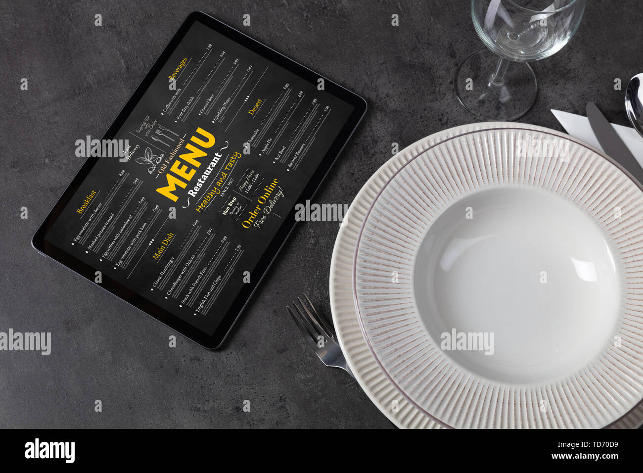 Empty plate and tableware with online order menu Stock Photo - Alamy