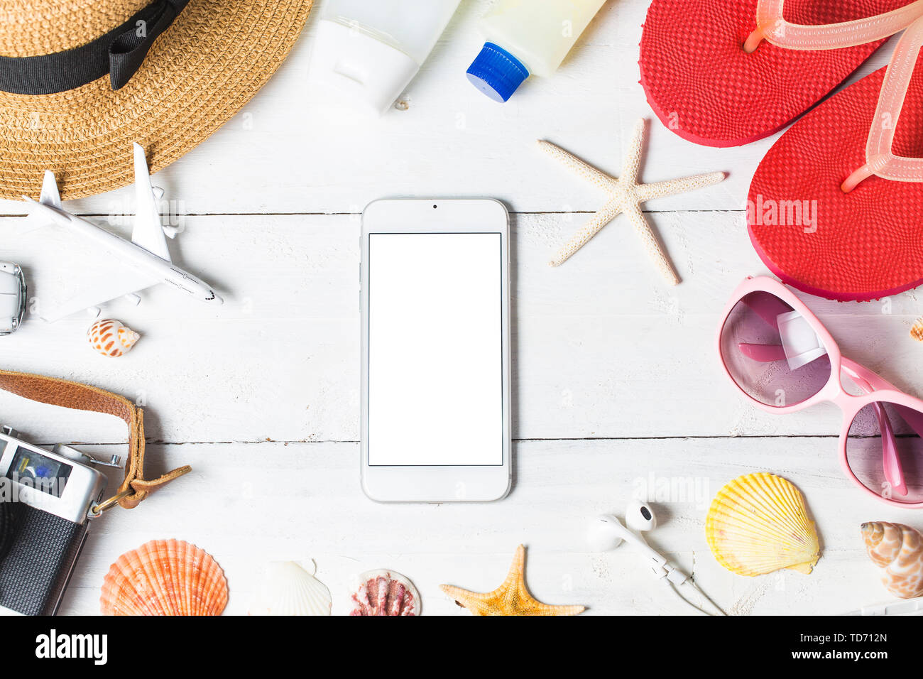 Beach accessories. Bag,towel,sunglasses and flip-flops on wooden ...