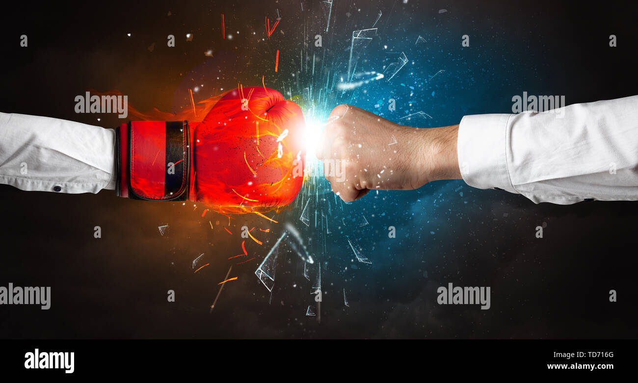 Two hands fighting and breaking glass into small pieces with fire and ...