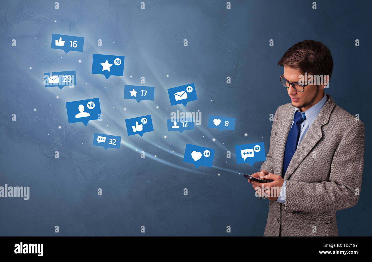 Young person using phone with flying social media icons around Stock ...