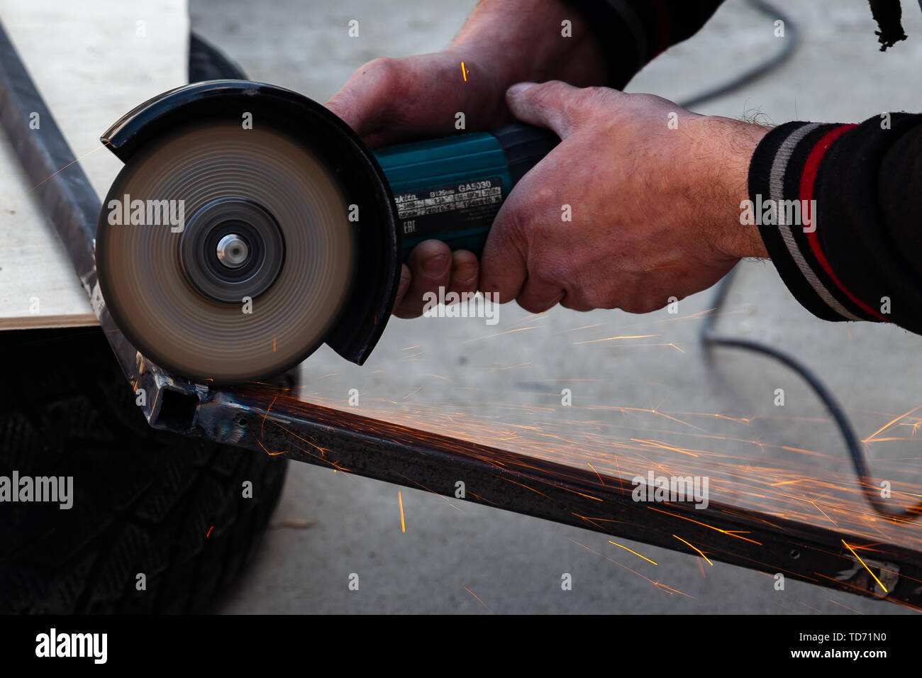 Close-up view strong man master without gloves on arms, performs metal ...