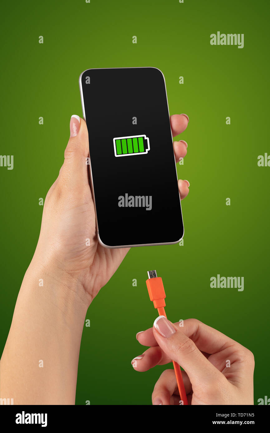 Elegant hand charging cellphone with low battery Stock Photo - Alamy