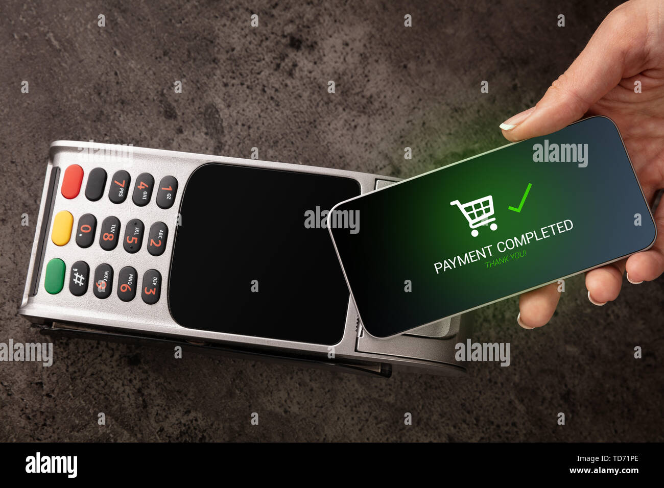 Mobile payment accepted on terminal Stock Photo - Alamy