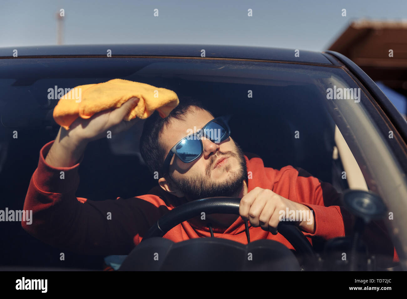 Photo of male with orange rag washing windshield Stock Photo - Alamy