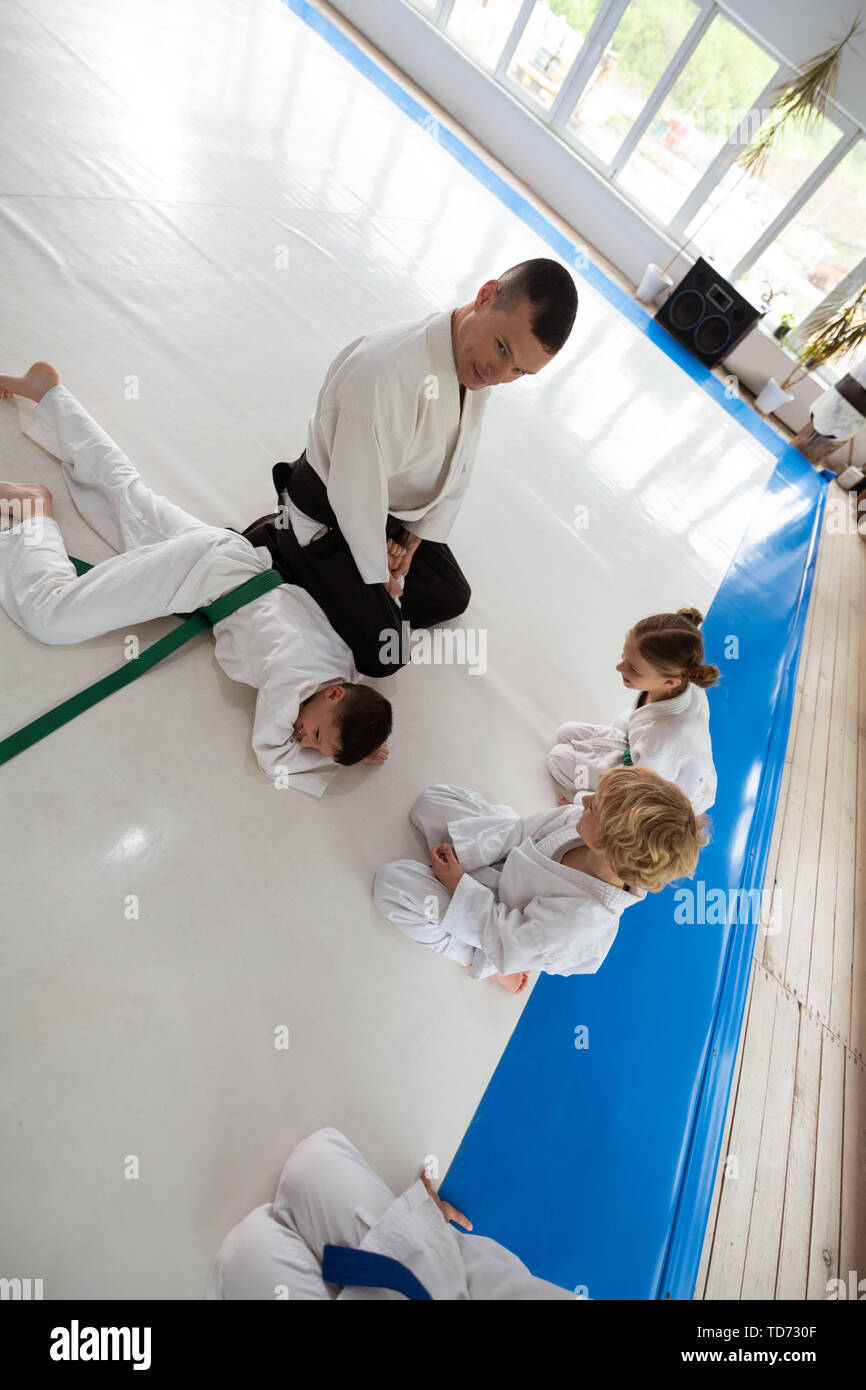 Children watching. Top view of active sportive children watching their ...
