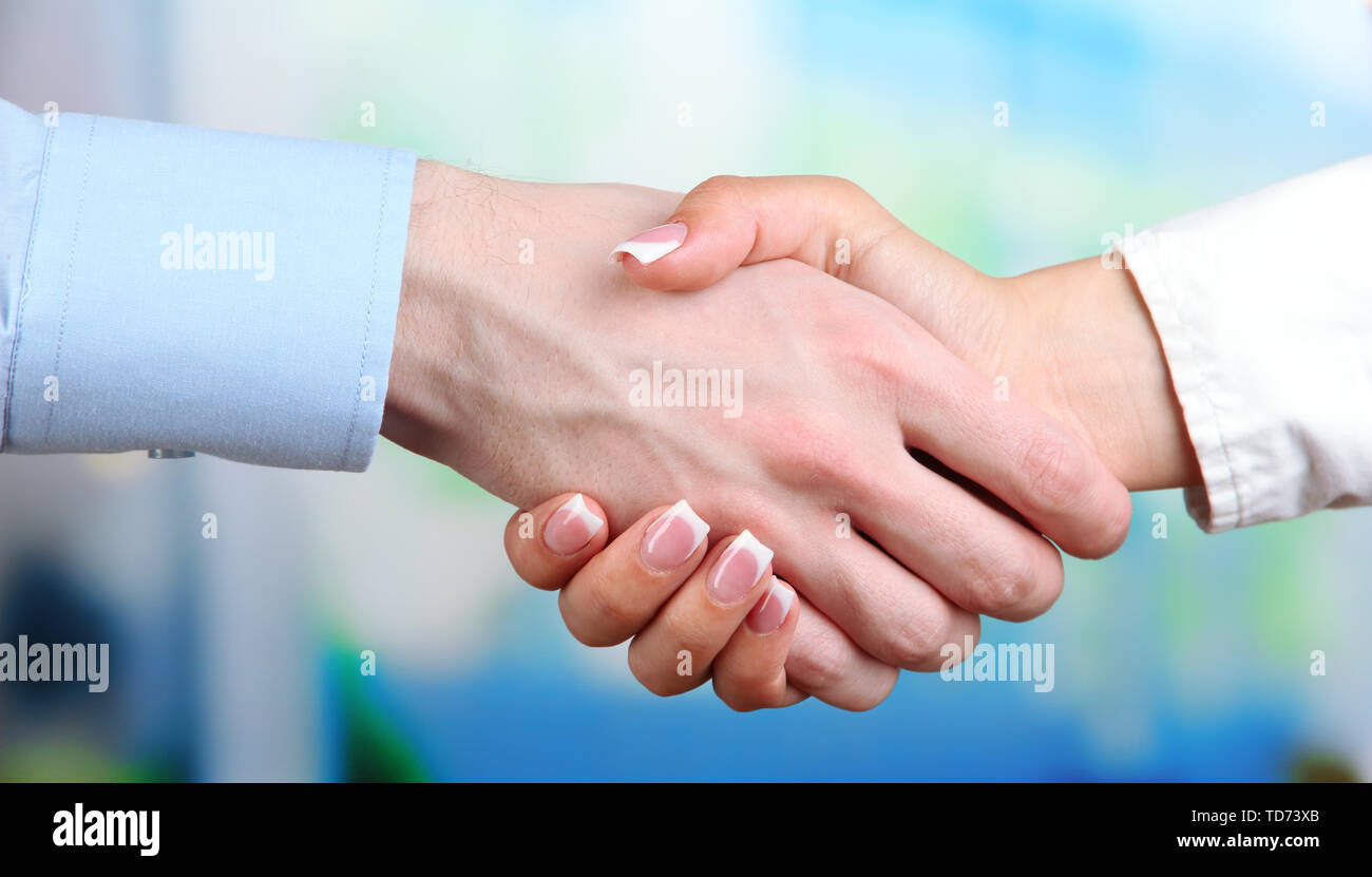 Business handshake on bright background Stock Photo - Alamy