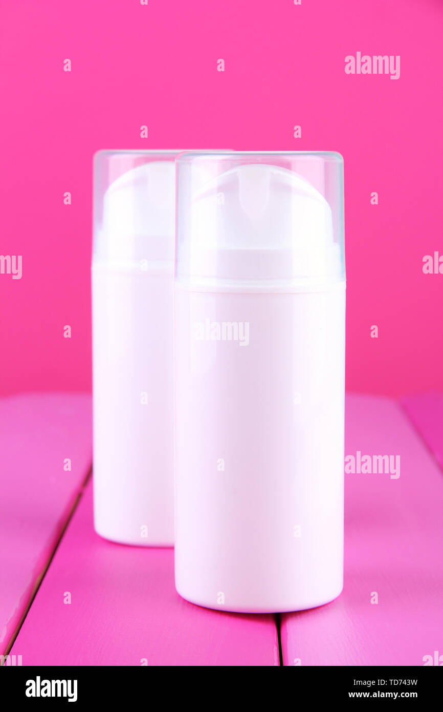 Bottle with cream, on color background Stock Photo - Alamy