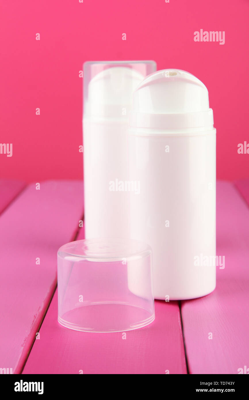 Bottle with cream, on color background Stock Photo - Alamy