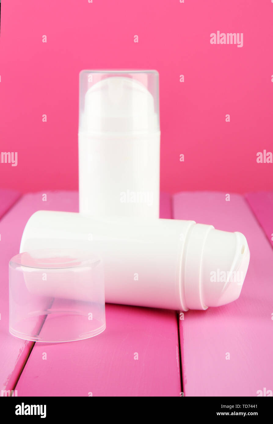 Bottle with cream, on color background Stock Photo - Alamy