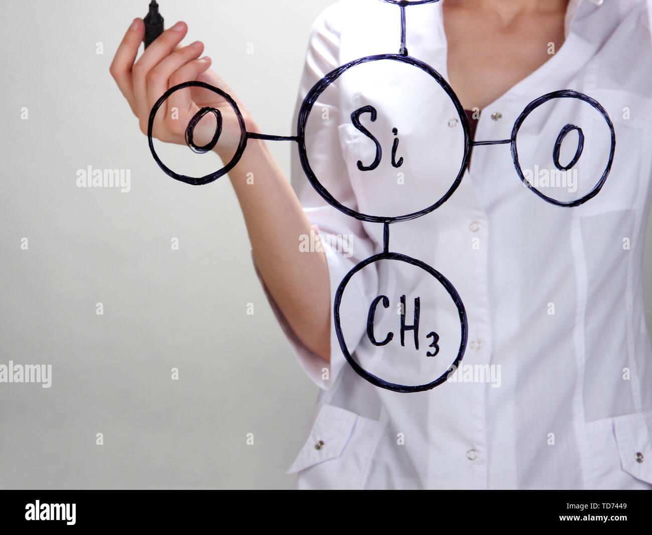 Chemist woman writing formulas on glass on grey background Stock Photo ...