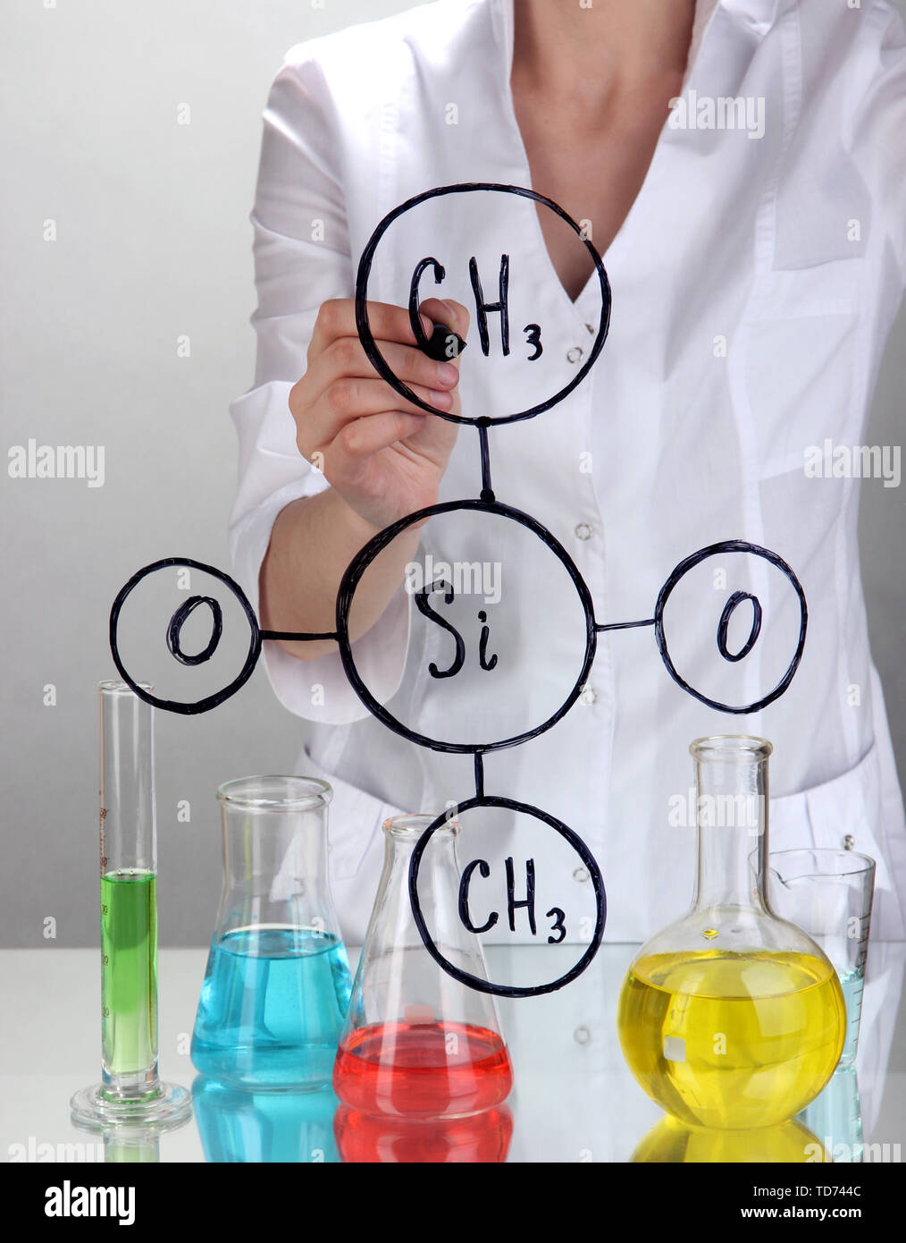 Chemist woman writing formulas on glass on grey background Stock Photo ...