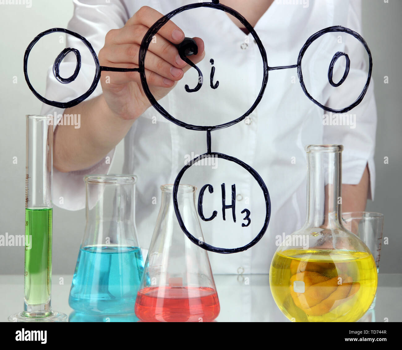 Chemist woman writing formulas on glass on grey background Stock Photo ...