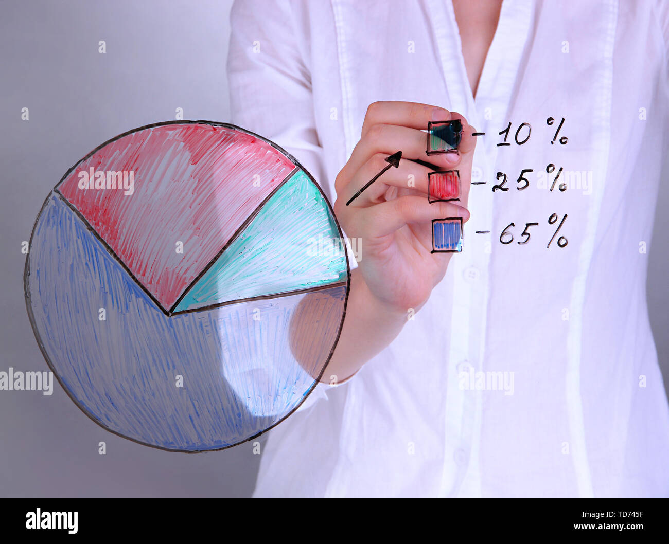 Woman paints graphic on glass on grey background Stock Photo - Alamy