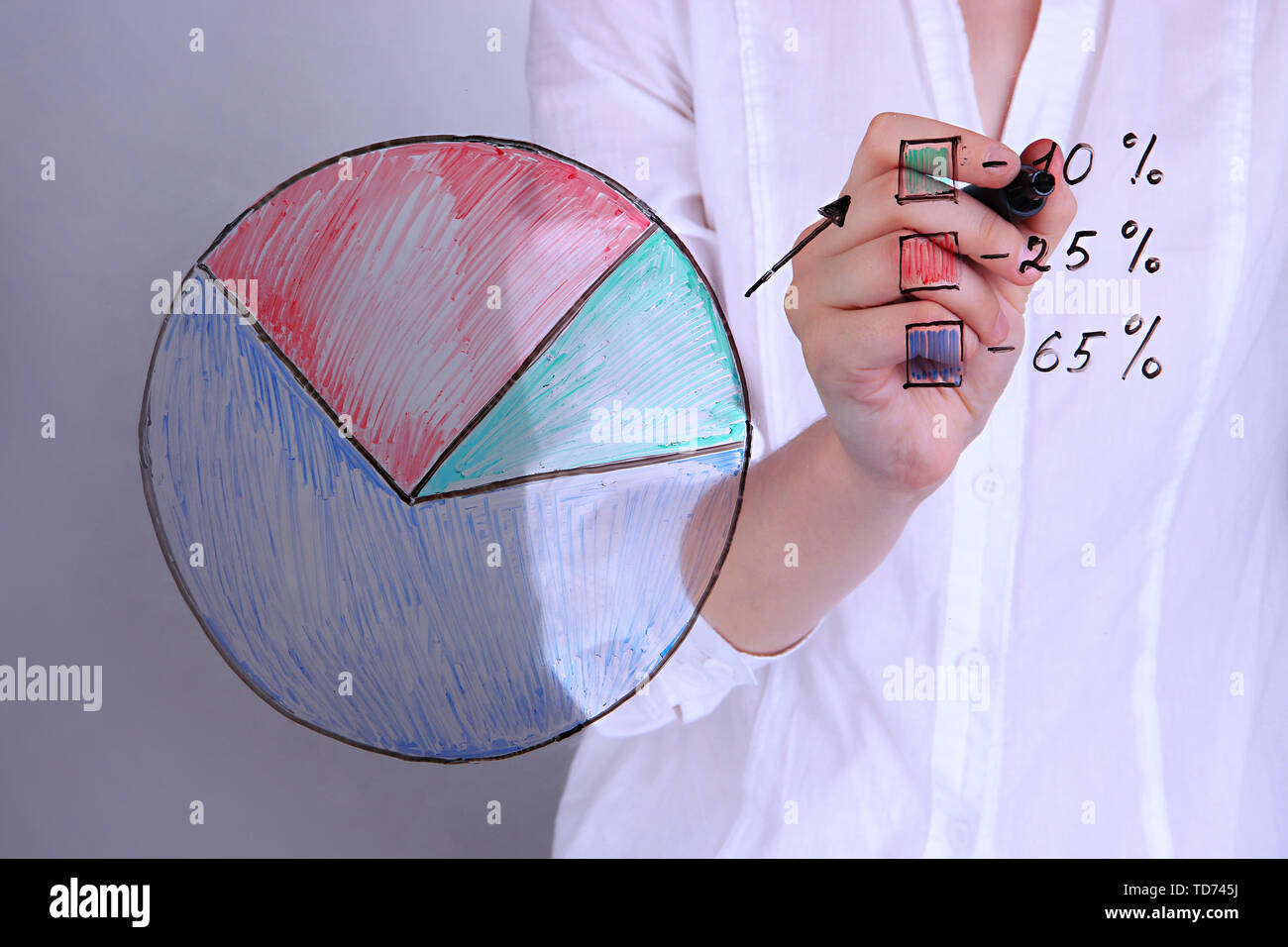 Woman paints graphic on glass on grey background Stock Photo - Alamy