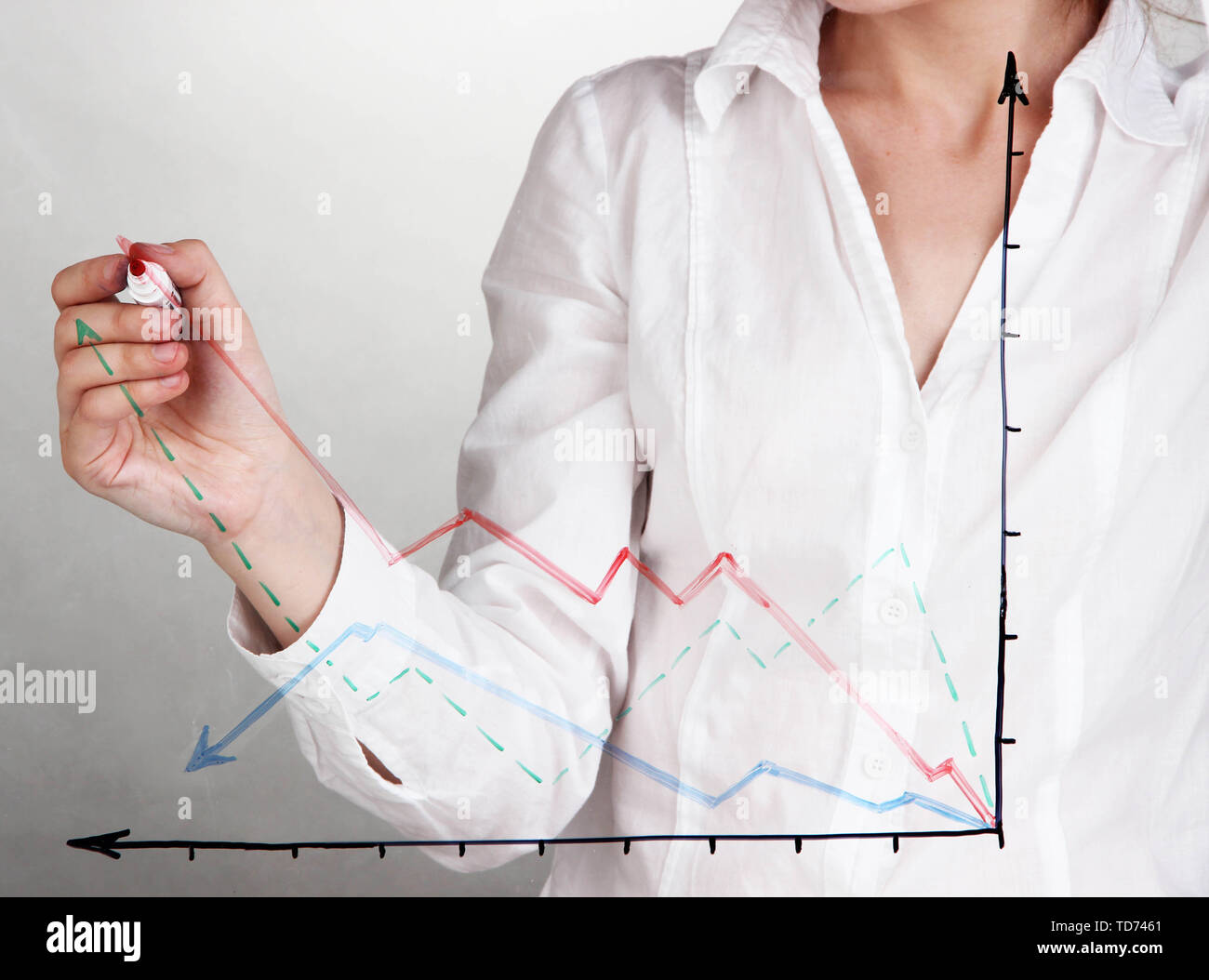 Woman paints graphic on glass on grey background Stock Photo - Alamy