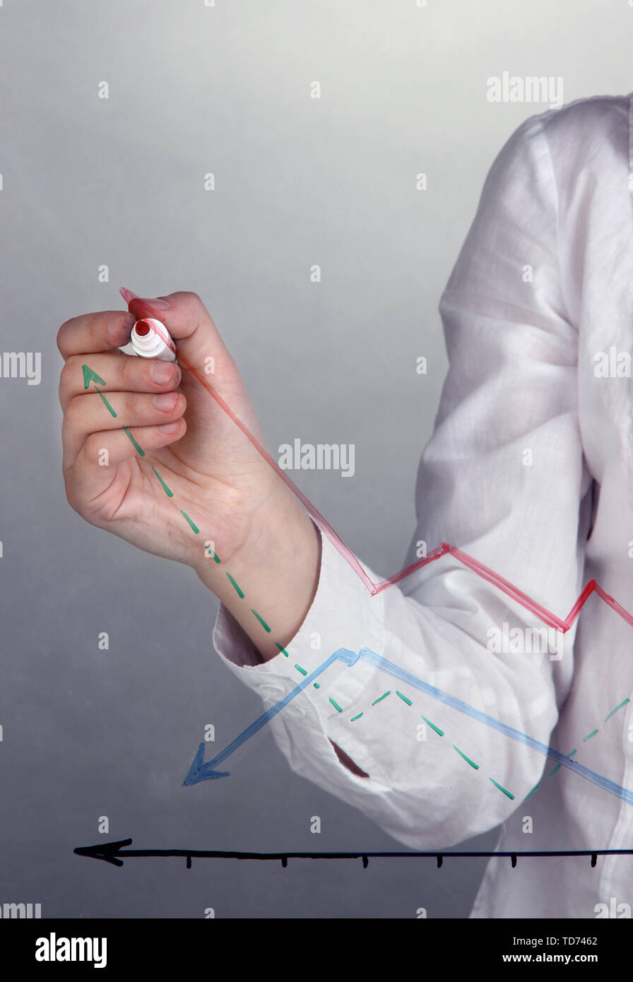 Woman paints graphic on glass on grey background Stock Photo - Alamy