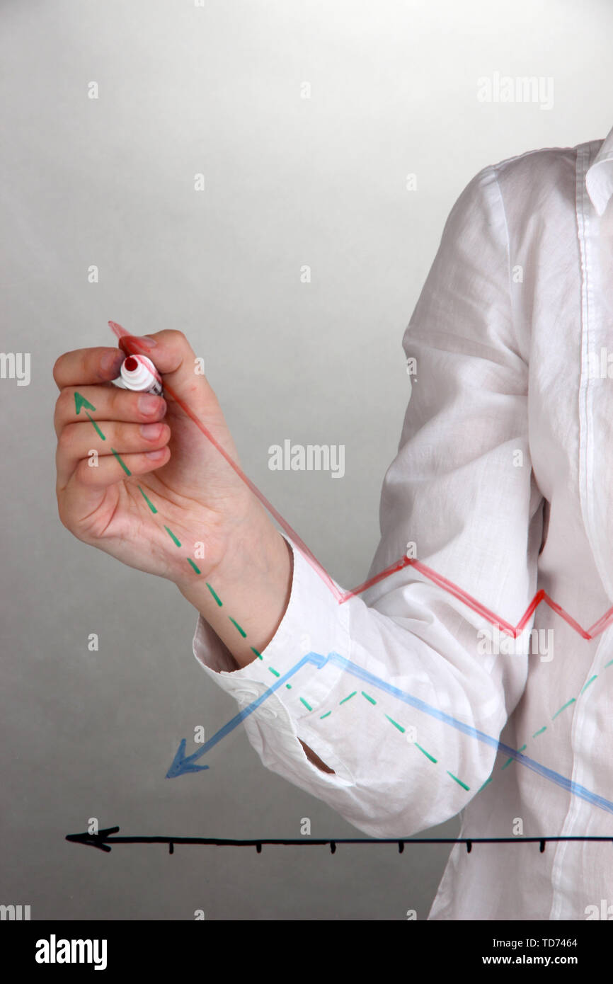 Woman paints graphic on glass on grey background Stock Photo - Alamy