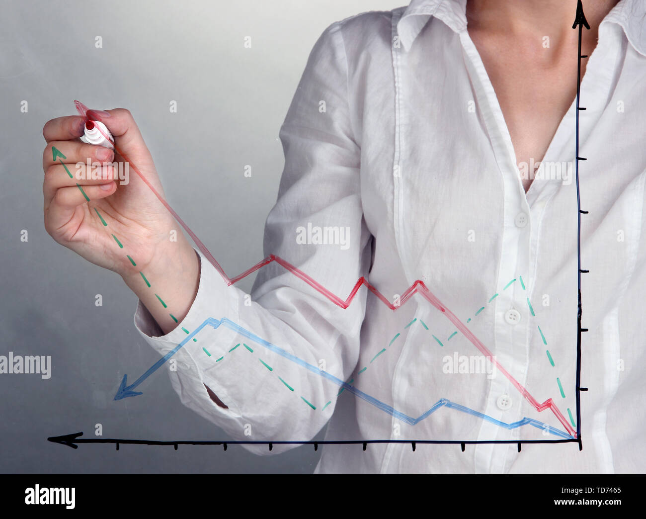 Woman paints graphic on glass on grey background Stock Photo - Alamy