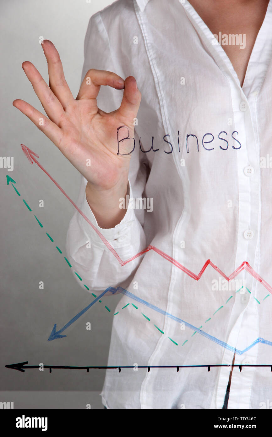 Woman paints graphic on glass on grey background Stock Photo - Alamy