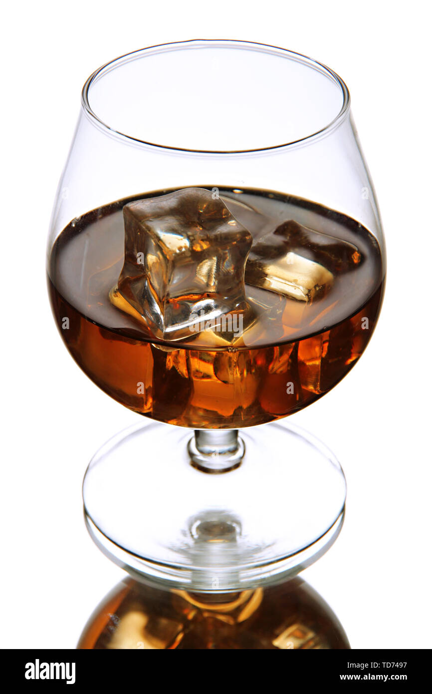 Brandy glass with ice on grey background Stock Photo - Alamy