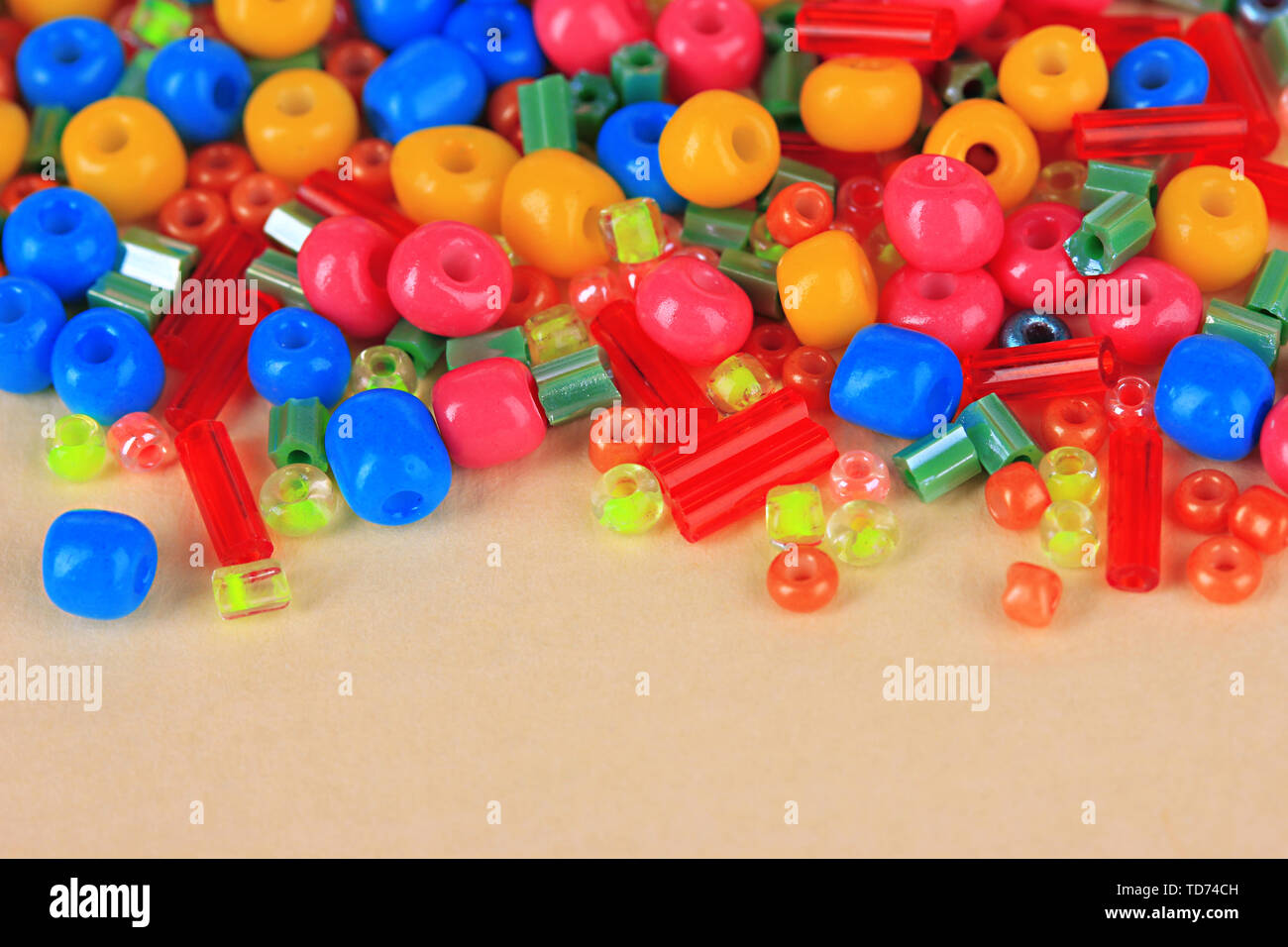 Different colorful beads on beige background Stock Photo - Alamy