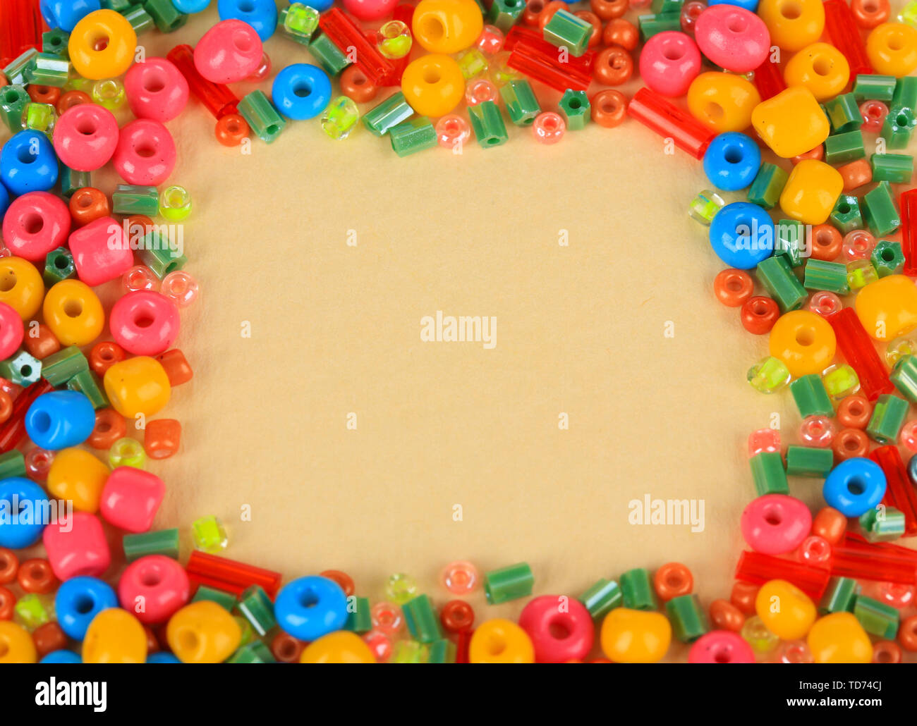 Different colorful beads on beige background Stock Photo - Alamy