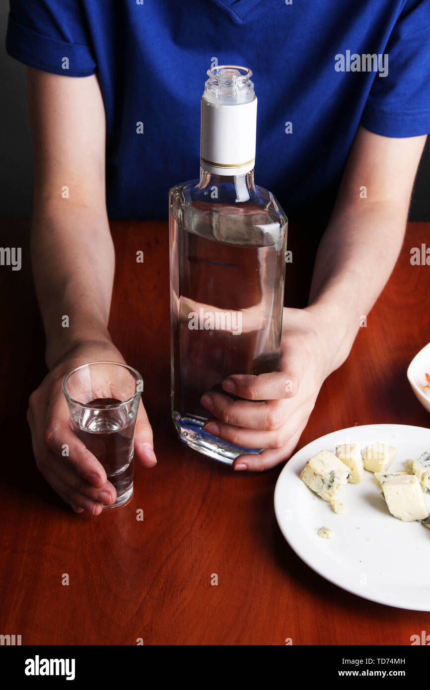 Drunk man drinks vodka at table close-up Stock Photo - Alamy