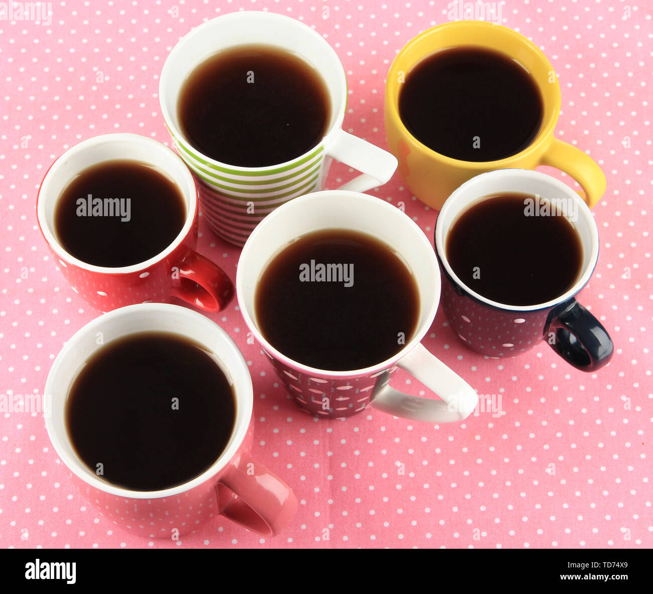 Many cups of coffee on pink napkin Stock Photo - Alamy