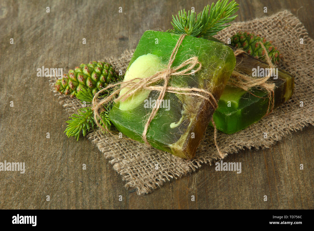 Hand-made soap and green pine cones on wooden background Stock Photo ...