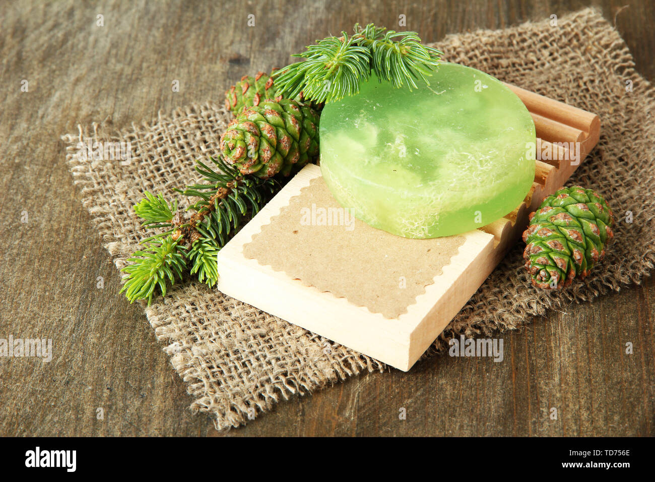 Hand-made soap and green pine cones on wooden background Stock Photo ...