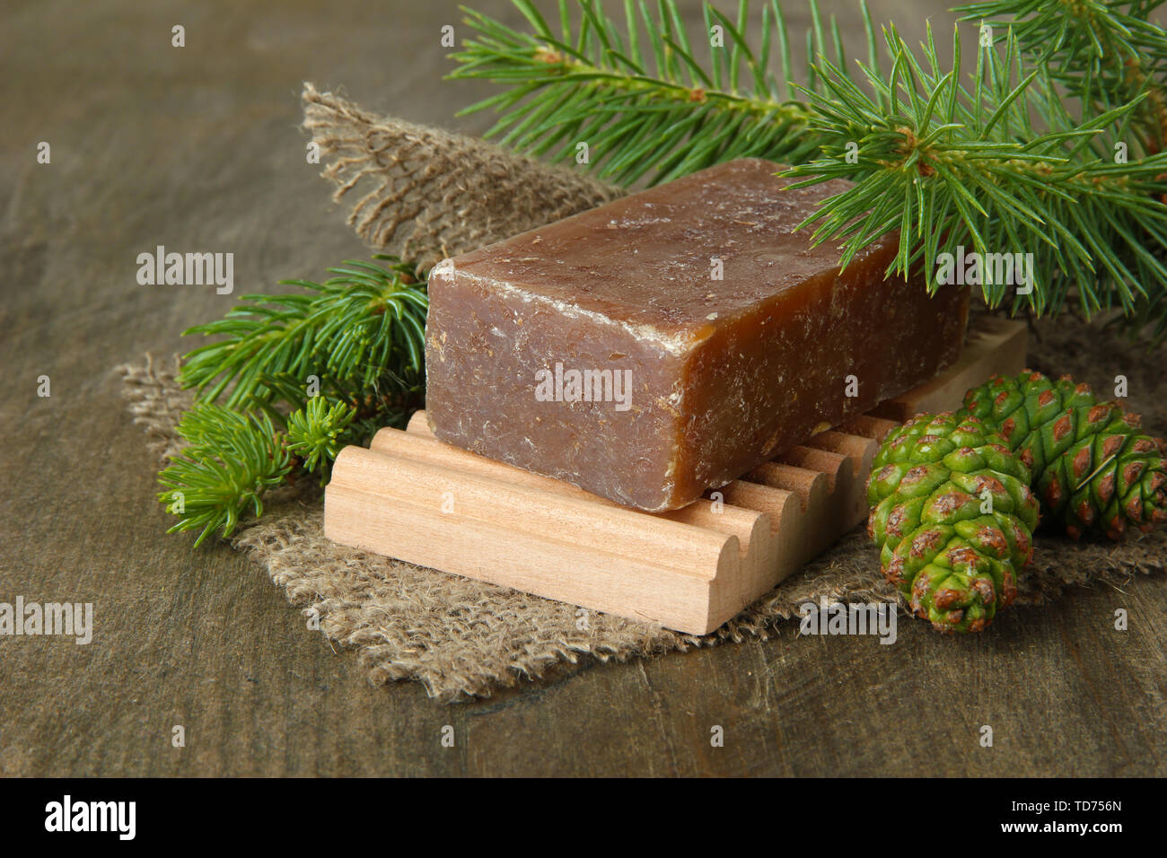 Hand-made soap and green pine cones on wooden background Stock Photo ...