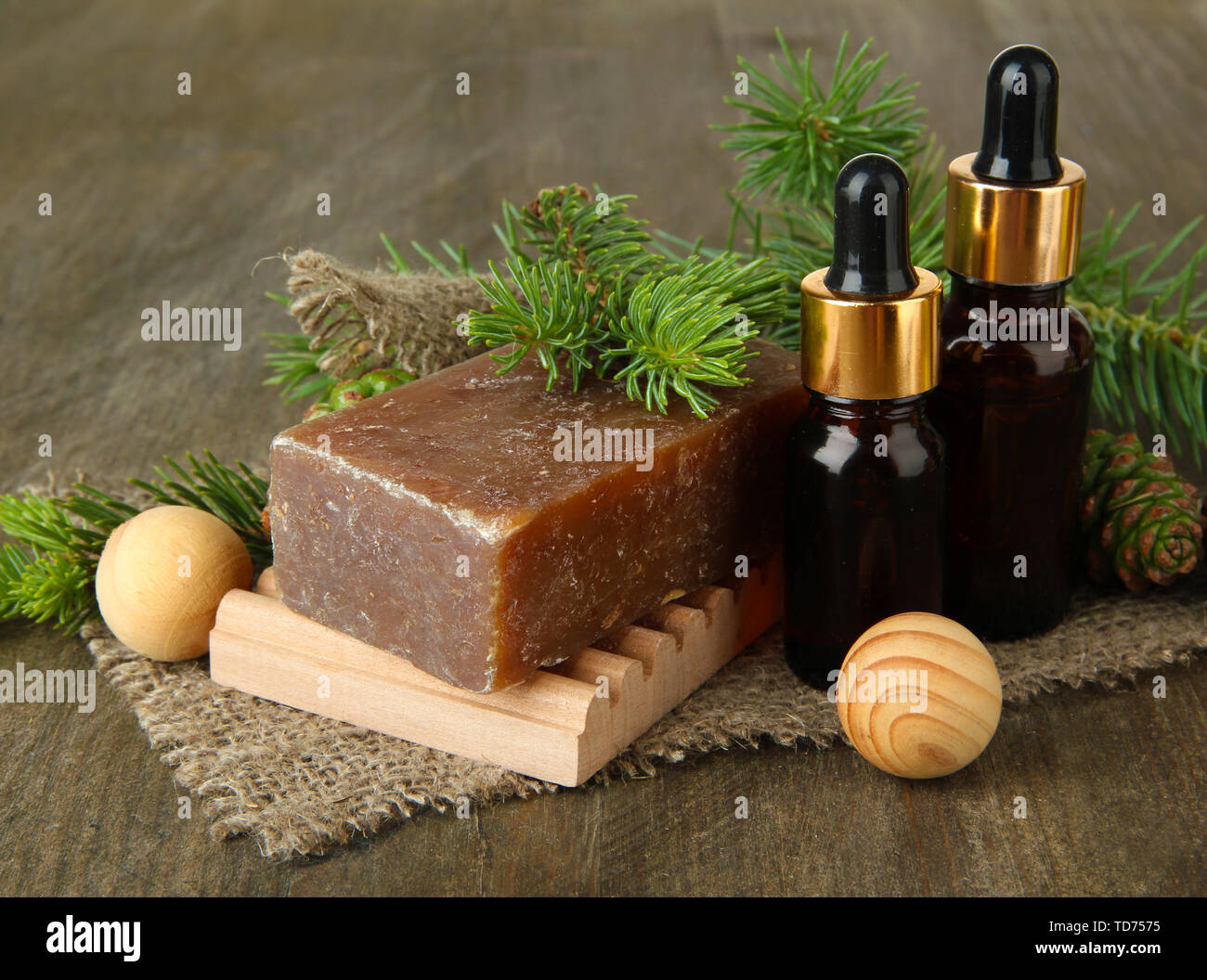 Hand-made soap and bottles of fir tree oil on wooden background Stock ...