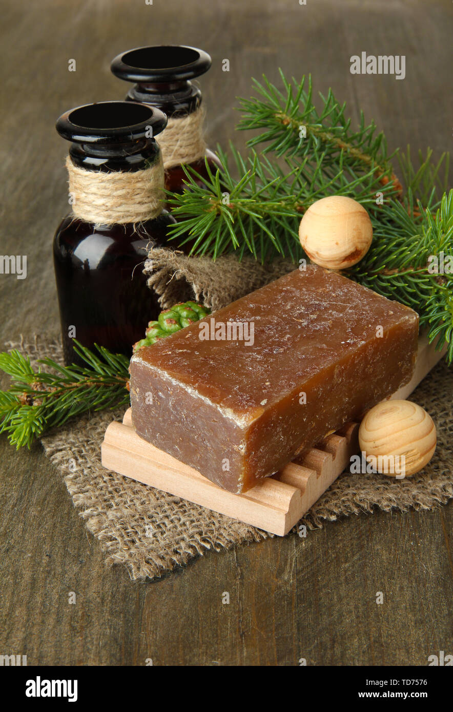 Hand-made soap and bottles of fir tree oil on wooden background Stock ...