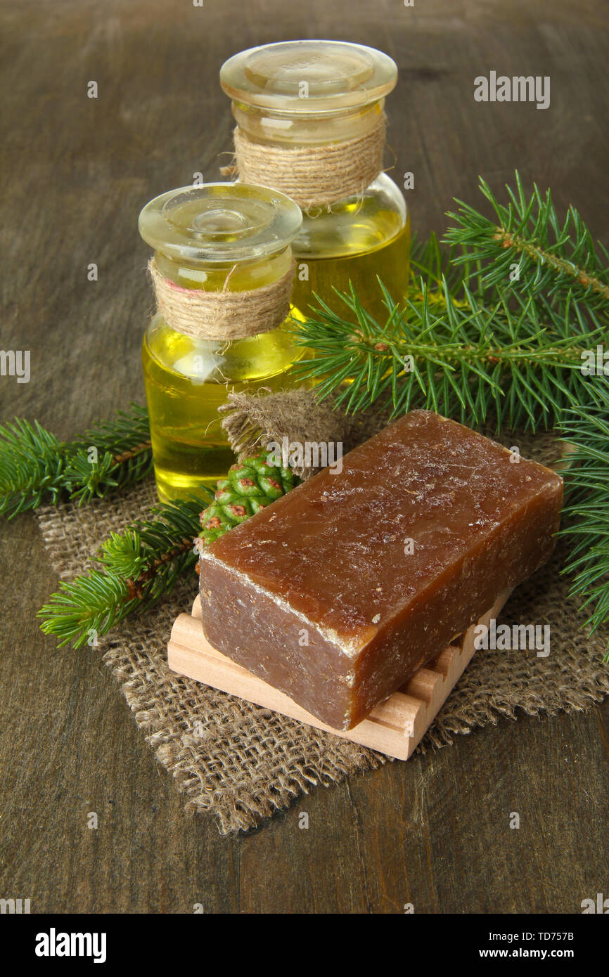 Hand-made soap and bottles of fir tree oil on wooden background Stock ...