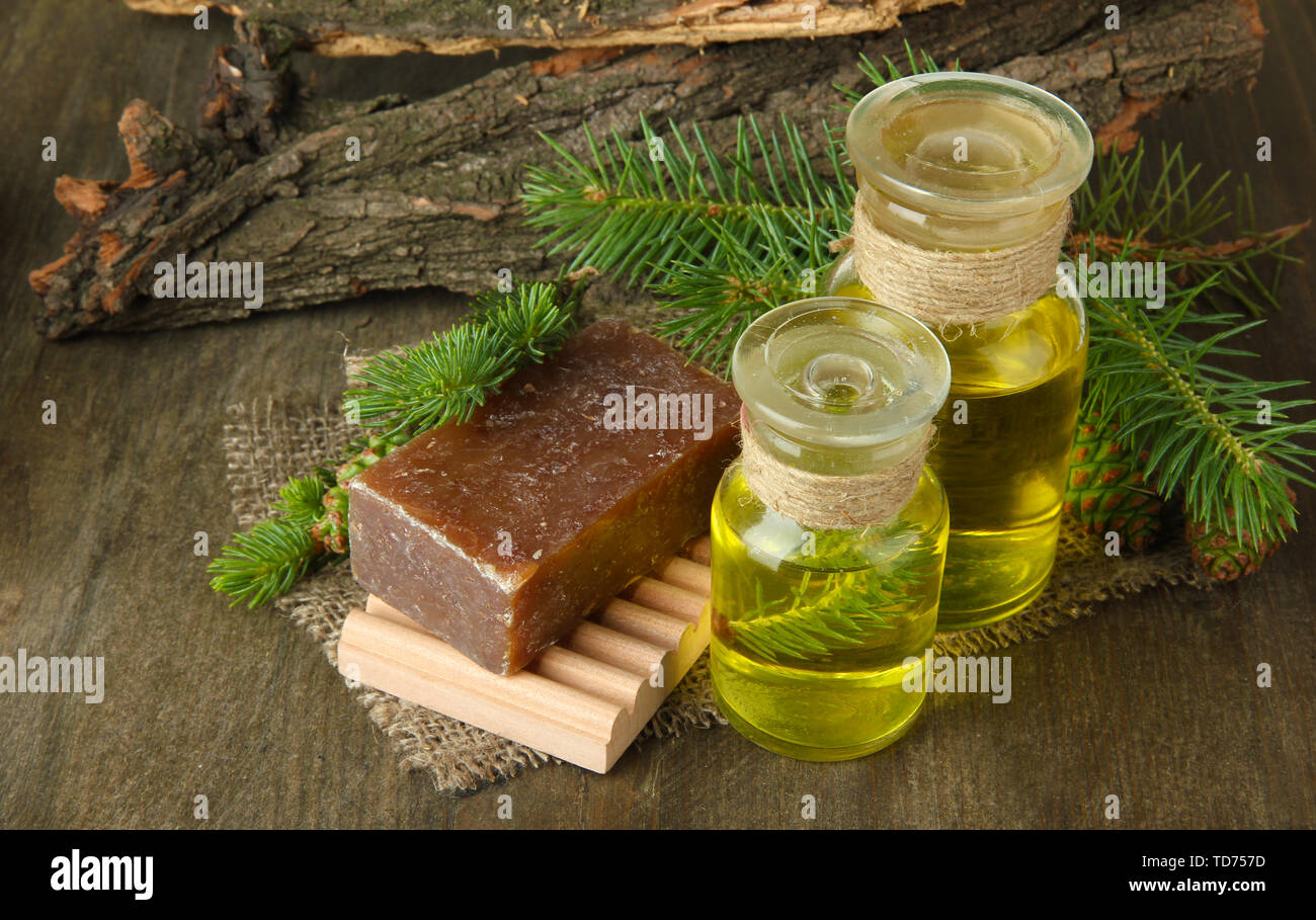 Hand-made soap and bottles of fir tree oil on wooden background Stock ...