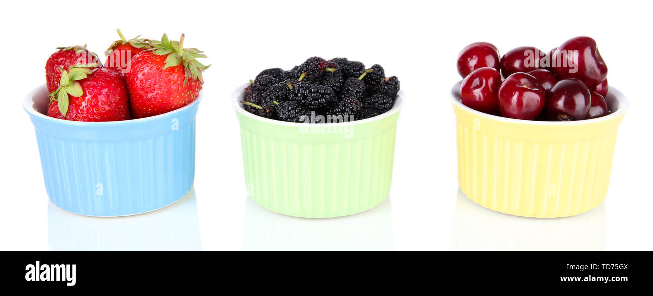 Ripe mulberries with cherry and strawberries in bowls isolated on white ...