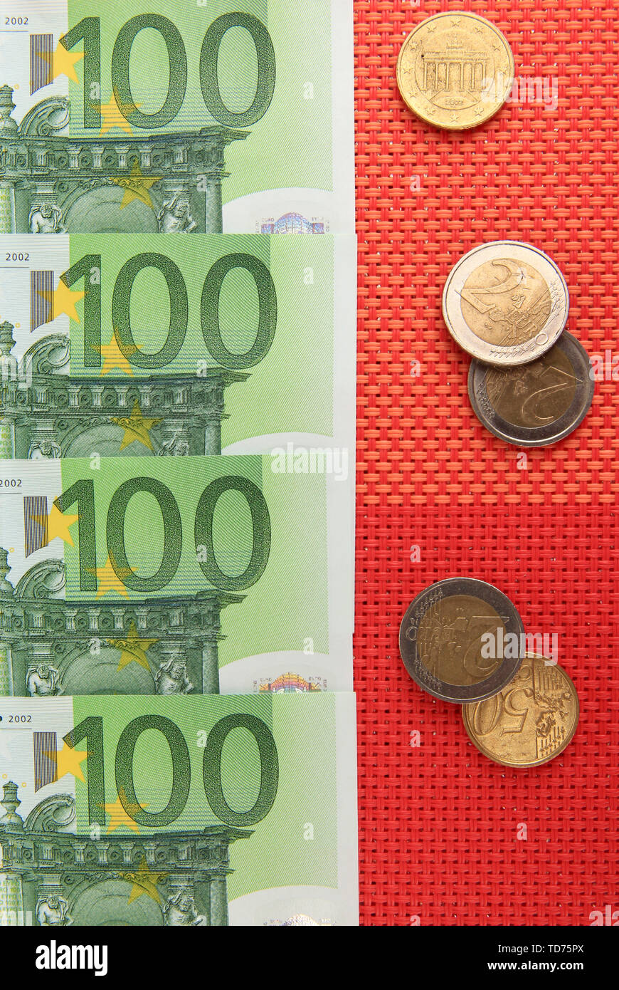 Euro banknotes and euro cents on red background Stock Photo - Alamy