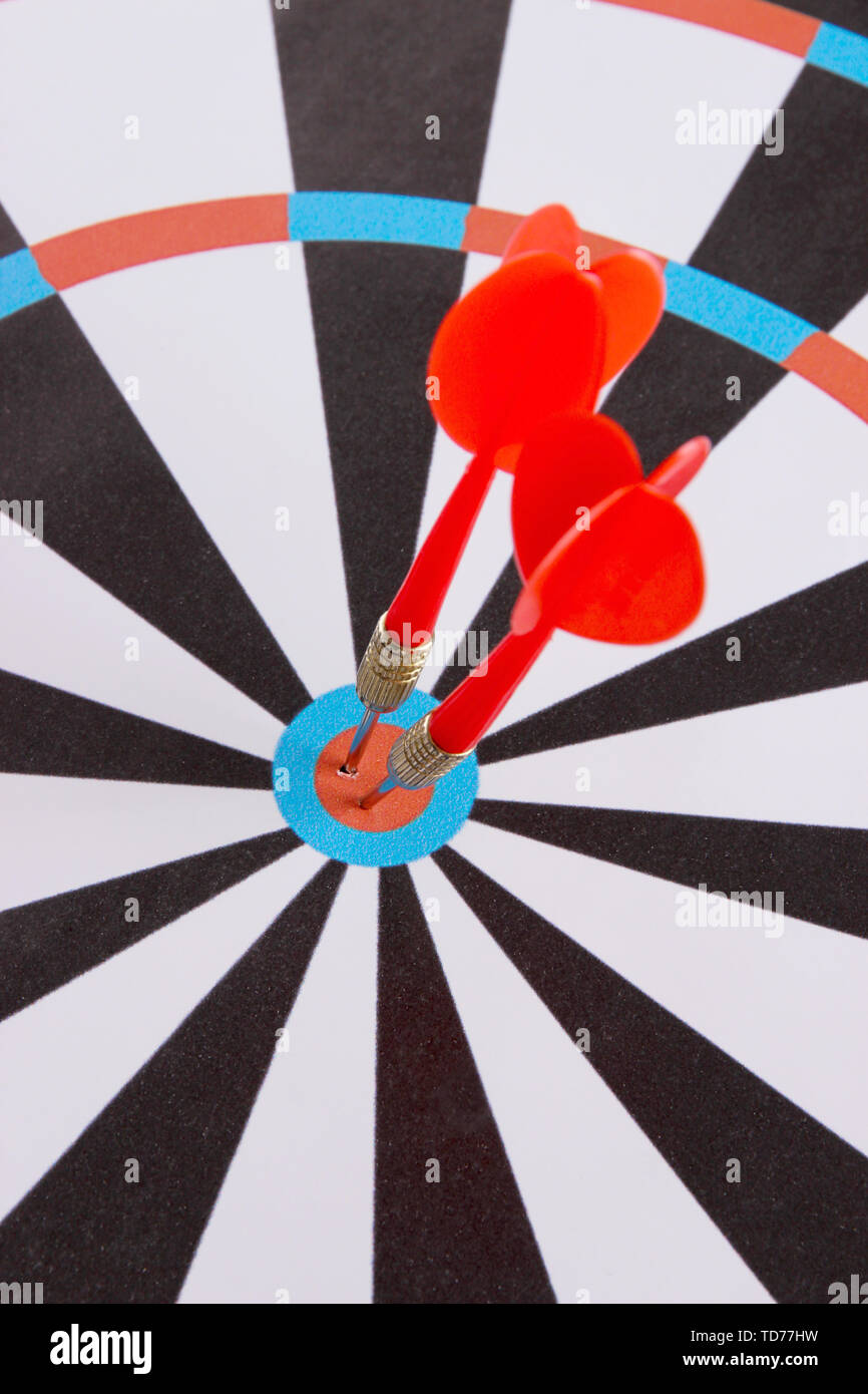 Target with darts close-up Stock Photo - Alamy