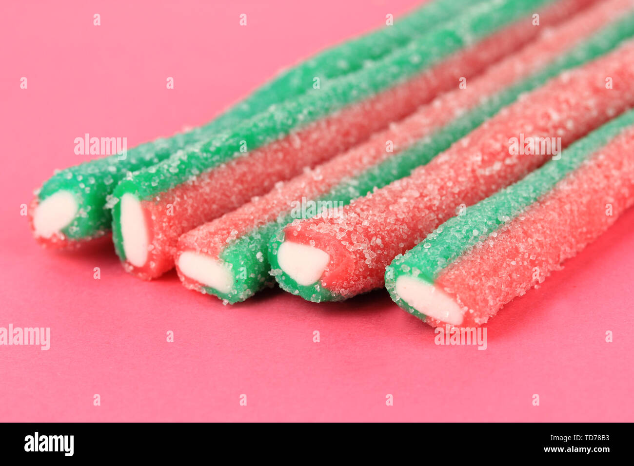 Sweet jelly candies on pink background Stock Photo - Alamy