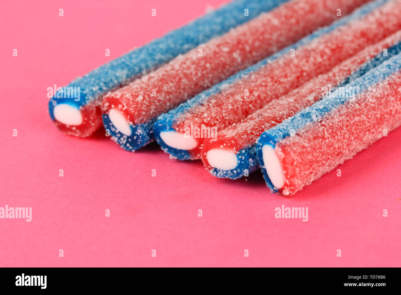 Sweet jelly candies on pink background Stock Photo - Alamy