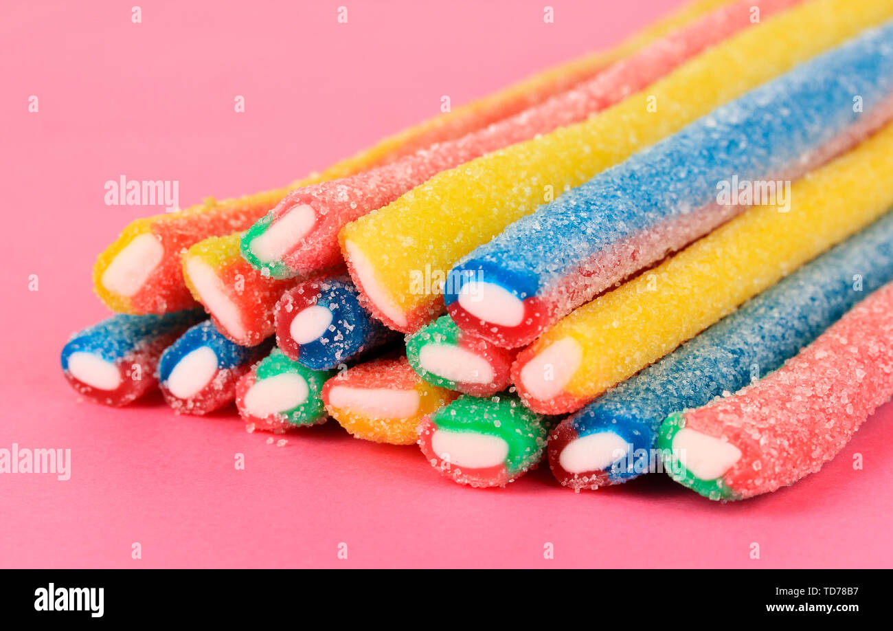 Sweet jelly candies on pink background Stock Photo - Alamy