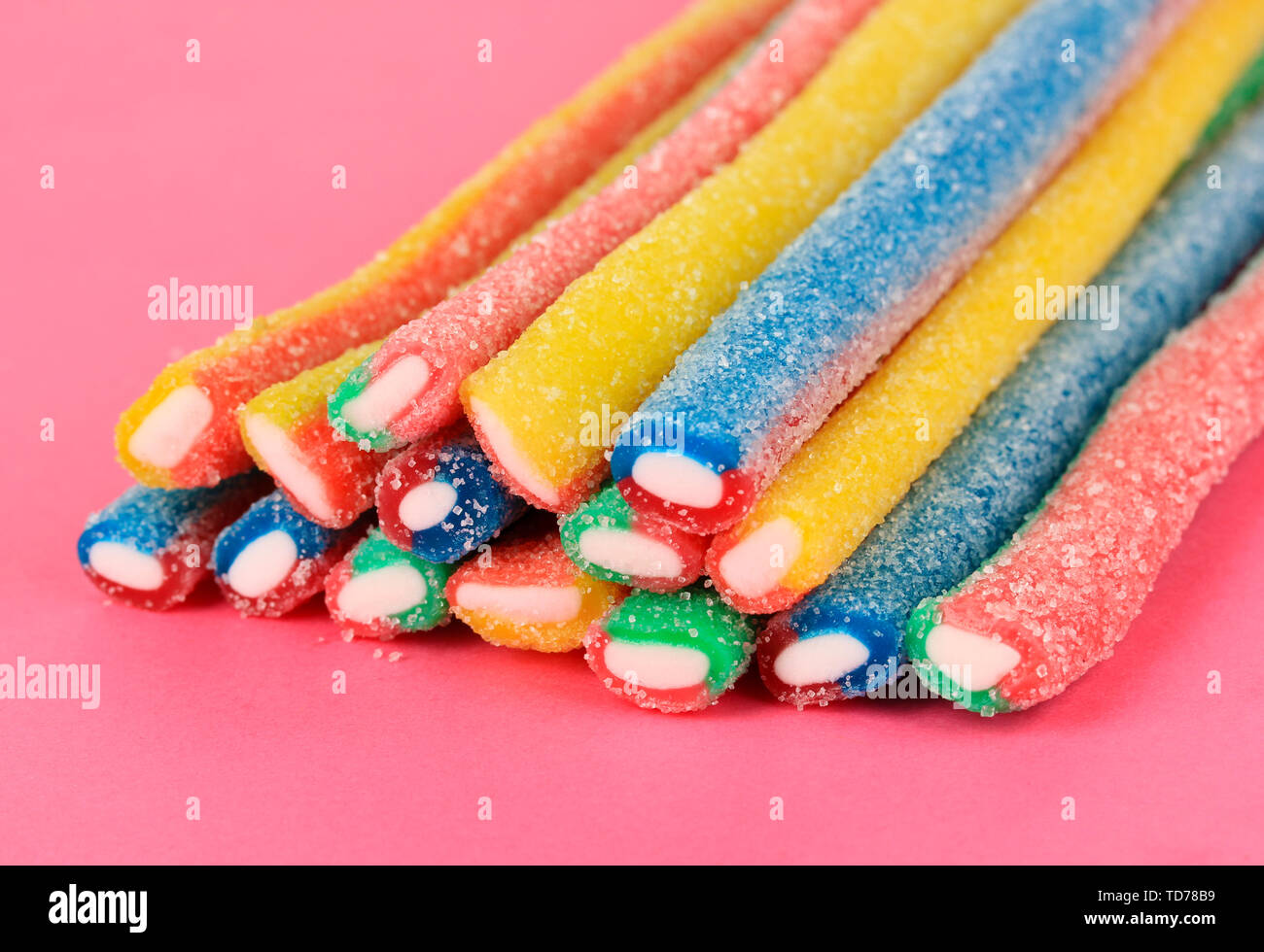 Sweet jelly candies on pink background Stock Photo - Alamy