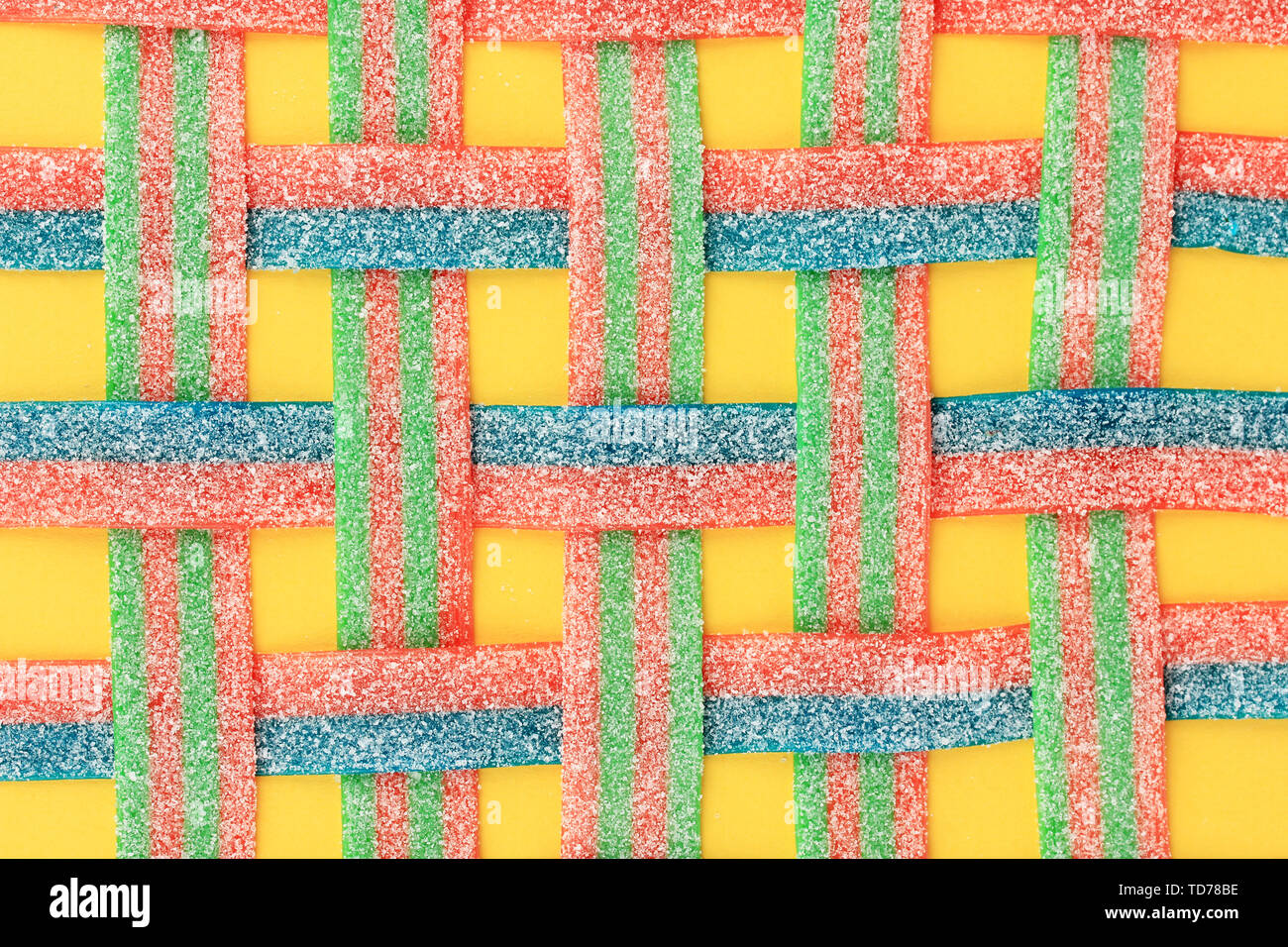 Sweet jelly candies on yellow background Stock Photo - Alamy